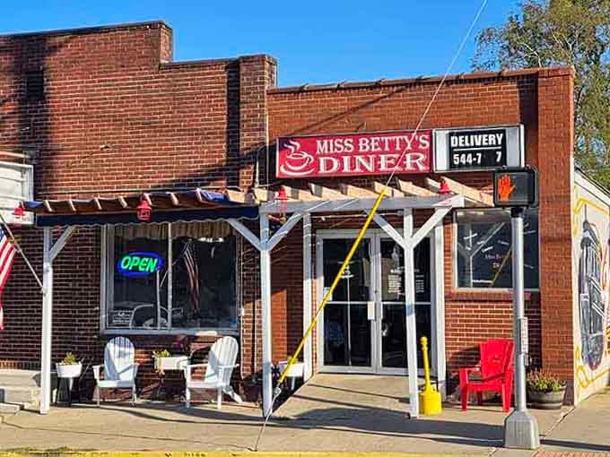 That wooden pergola and patriotic flag signal hometown hospitality where everyone's treated like family at Miss Betty's.
