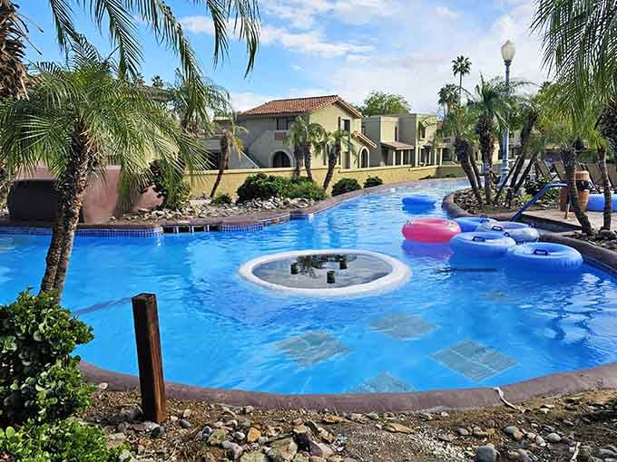 The lazy river curves past Spanish-style buildings, creating a resort vibe that makes ordinary Tuesdays feel like vacation.