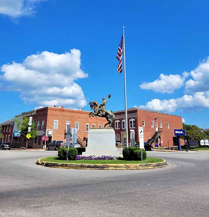 A patriotic statue anchors this town square where community pride practically radiates from every brick and flagpole.