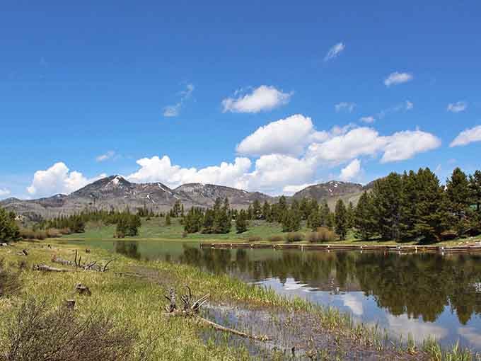 Lush green meadows embrace this tranquil lake, creating a scene straight from a landscape painter's dream.
