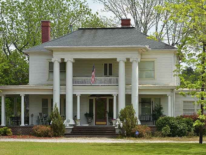 This stately Southern home with its grand columns practically begs you to sit on that porch with sweet tea.