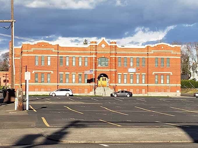 This grand brick building glows golden in the sunlight, anchoring downtown with timeless architectural grace and presence.