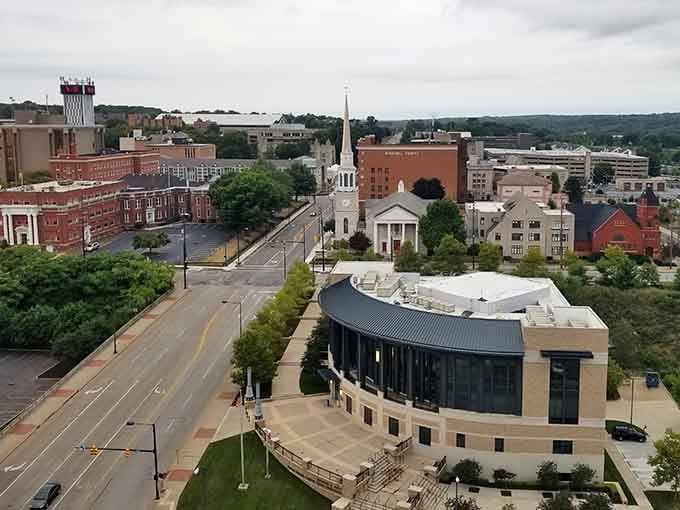 Tree-lined streets and church steeples create a skyline that balances old-world charm with contemporary community spaces below.