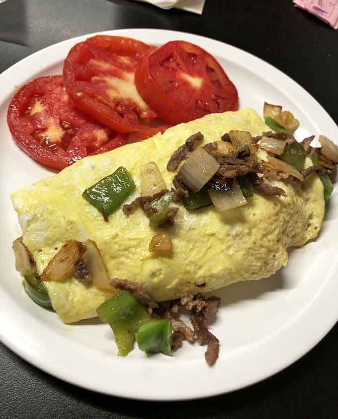 This fluffy Philly cheese steak omelette loaded with peppers and onions proves breakfast can be both hearty and sophisticated.