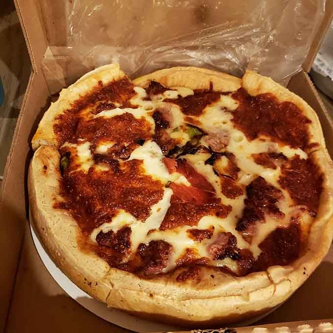 Behold the deep dish in all its glory, cheese stretching like it's auditioning for a commercial.