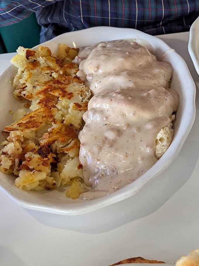 Behold the plate that launched a thousand satisfied sighs: fluffy biscuits drowning in peppery sausage gravy perfection.
