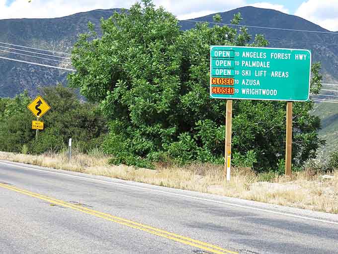 Road status signs keeping you informed, because nobody wants surprises when you're planning mountain adventures.