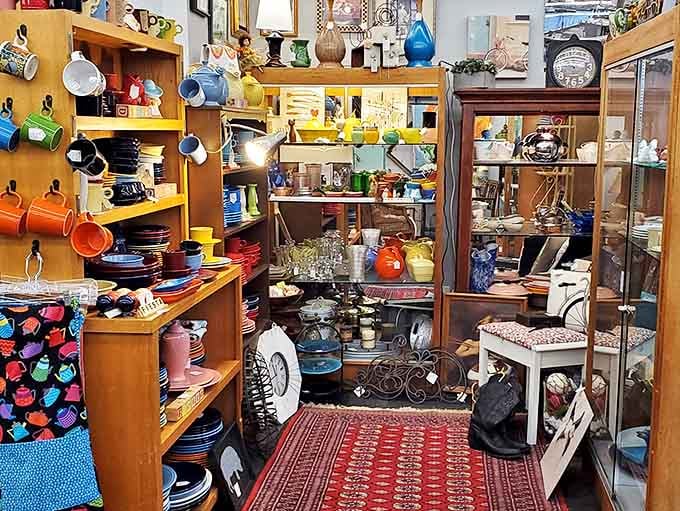 Colorful dishware stacked like a rainbow exploded in the best possible way across these shelves.