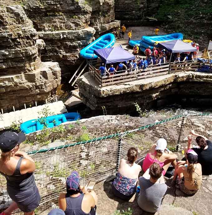 Rafts at the ready, visitors gather for their turn to float through ancient stone corridors carved by patient water.