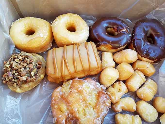 A baker's dozen of pure joy: glazed, chocolate, glazed with nuts, and donut holes that never stood a chance.