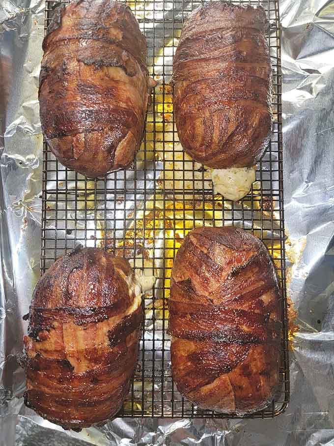 Bacon-wrapped perfection fresh from the smoker, glistening like edible treasure that'll haunt your dreams forever.