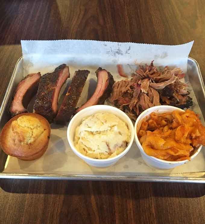 Sliced brisket with that perfect smoke ring, pulled pork glistening with moisture, this is the good stuff.