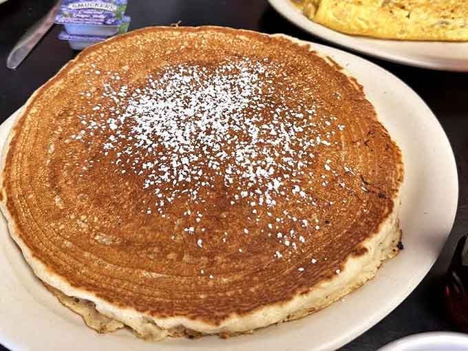 That pancake is roughly the size of a dinner plate and twice as beautiful as most sunrises.