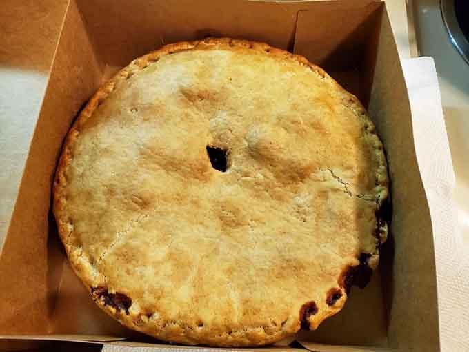 Behold the perfect pie: golden crust, bubbling fruit filling, and a steam vent that promises pure deliciousness inside.