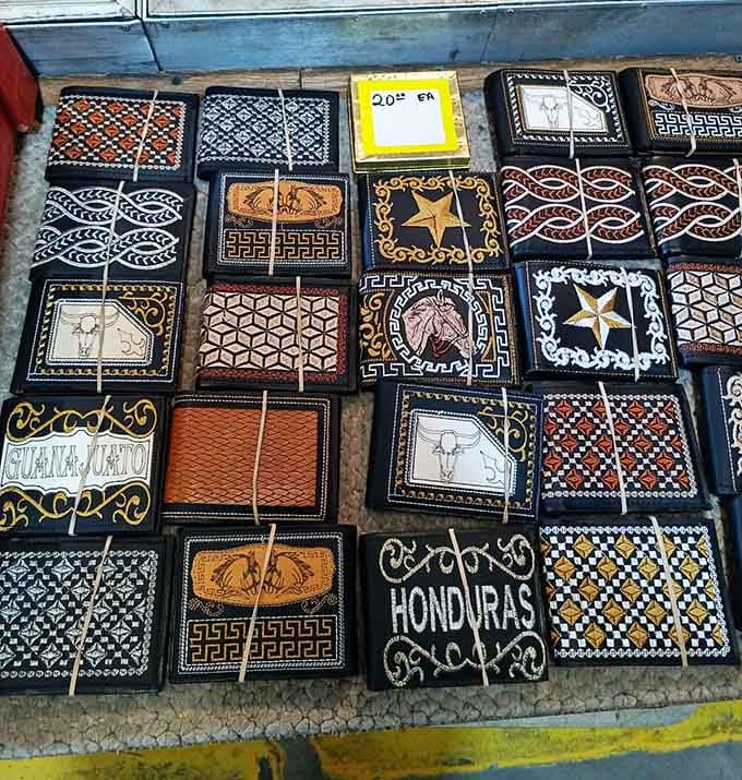 Leather wallets lined up like soldiers, each one promising to organize your life better than the last.