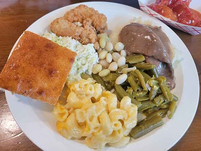 This plate tells the whole Southern story: crispy chicken, tender pork, creamy sides, and cornbread that means business.