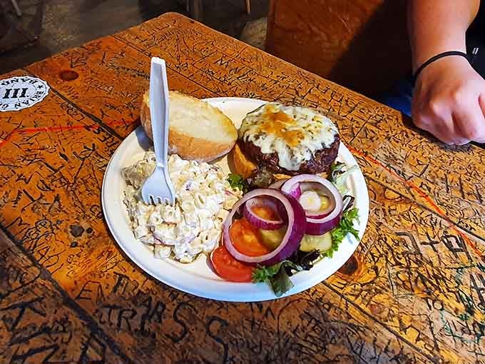 That burger sits there like it owns the place, topped with a fried egg because sometimes breakfast and lunch need a reunion.