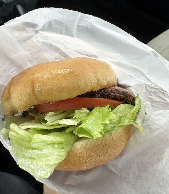 The deluxe burger arrives wrapped in paper, looking exactly like what your grandparents ate on their first date.