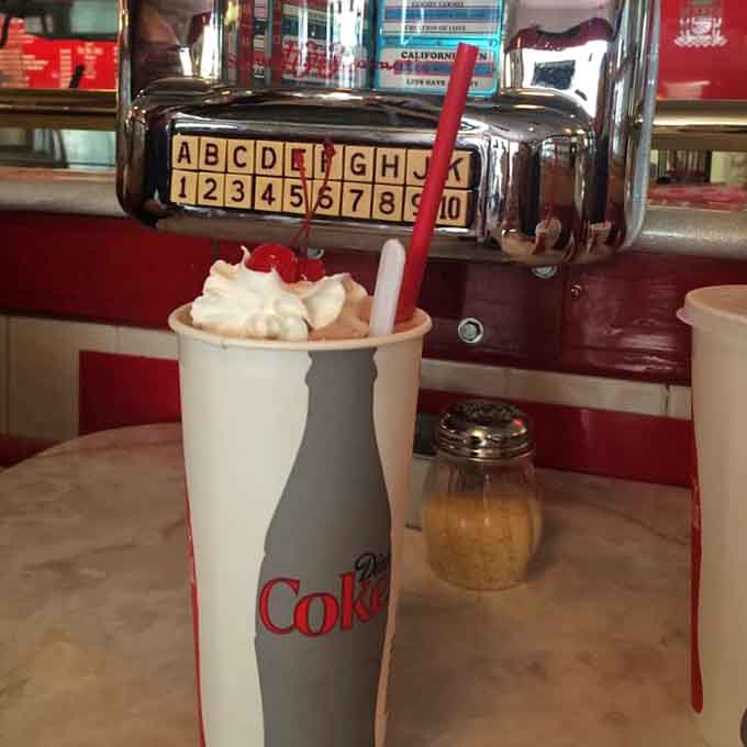 Whipped cream piled so high it needs its own zip code, crowned with a cherry of pure joy.