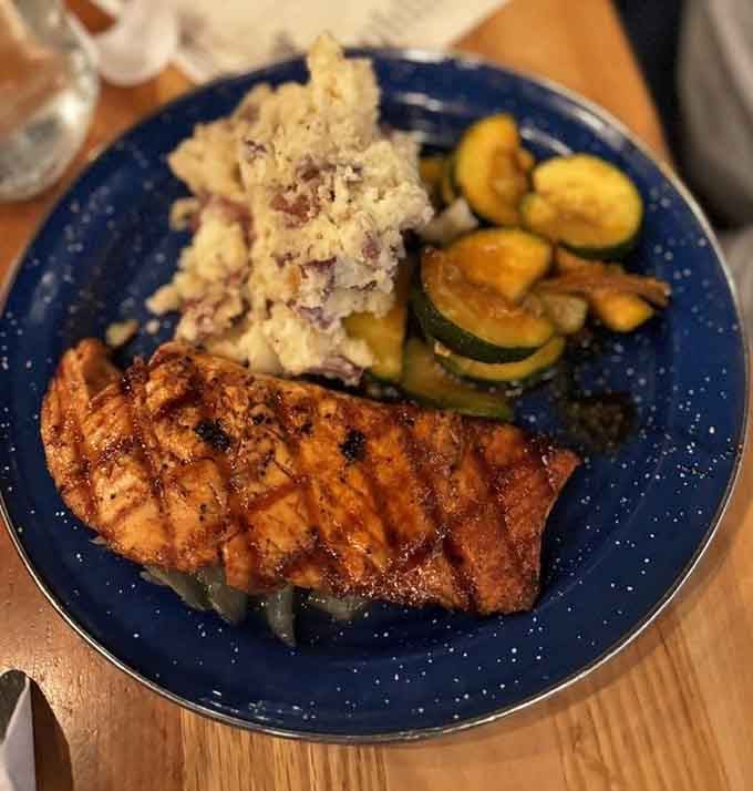Perfectly grilled salmon with sides that look this good? You're definitely not cooking this over a campfire in the woods.