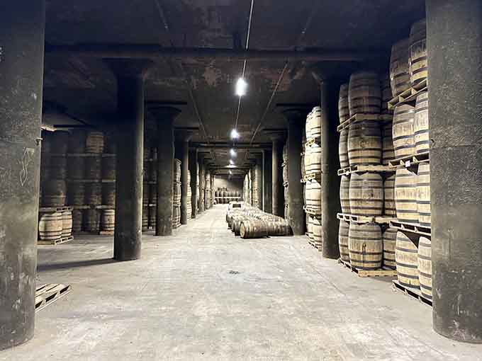Row after row of aging barrels sleep in darkness, quietly becoming the good stuff while we impatiently wait.