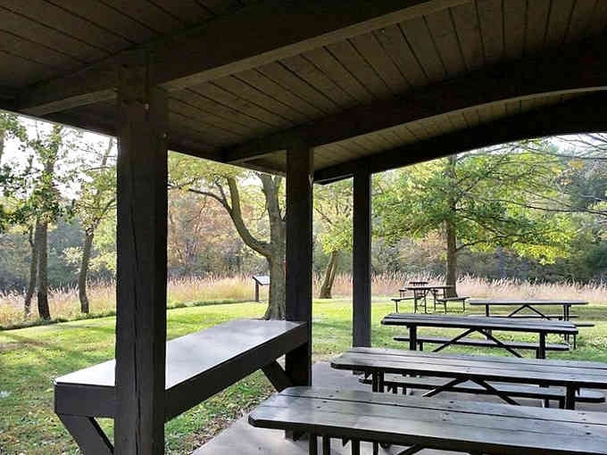Classic picnic shelter waiting for your potato salad and stories, with autumn colors providing the perfect backdrop for memories.