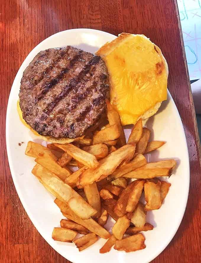 That's not a burger, that's a commitment, featuring a thick patty and melted cheese that demands your full attention.