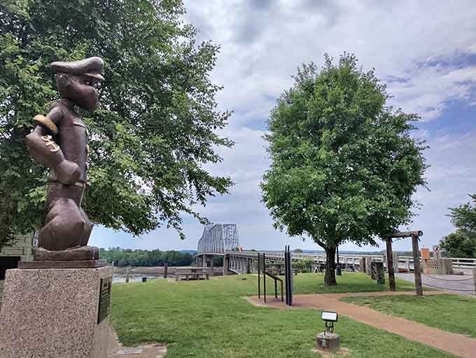 The mighty Mississippi flows behind Popeye's bronze statue, creating a view that's equal parts Americana and pure magic.