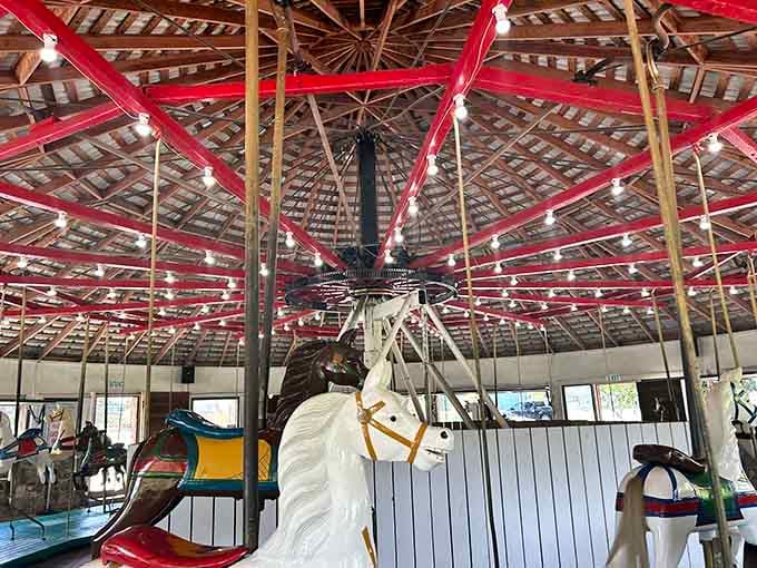 Hand-carved wooden steeds stand ready beneath a ceiling that's practically an engineering marvel in itself.