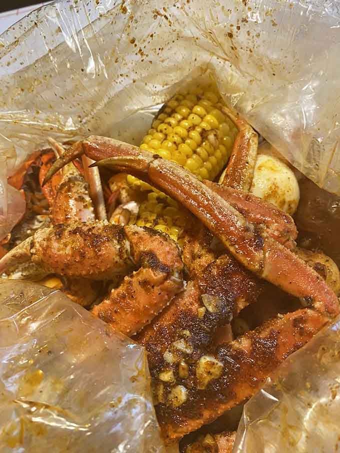 Crab legs glistening with Cajun seasoning alongside buttery corn prove that messy eating is the most honest eating.