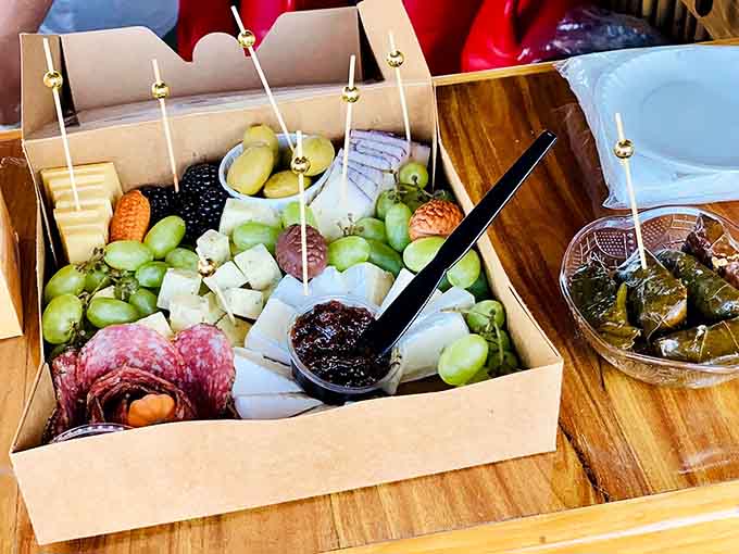This charcuterie spread proves you can bring the fancy to the water, complete with grapes, cheese, and tiny forks.