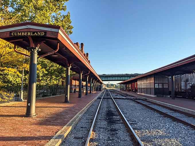 Golden hour at the station where steel rails stretch toward mountain adventures and childhood train fantasies come alive.