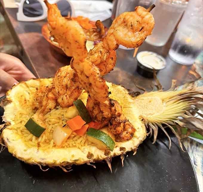 Shrimp served in a pineapple boat because apparently dinosaurs knew how to party in the tropics.