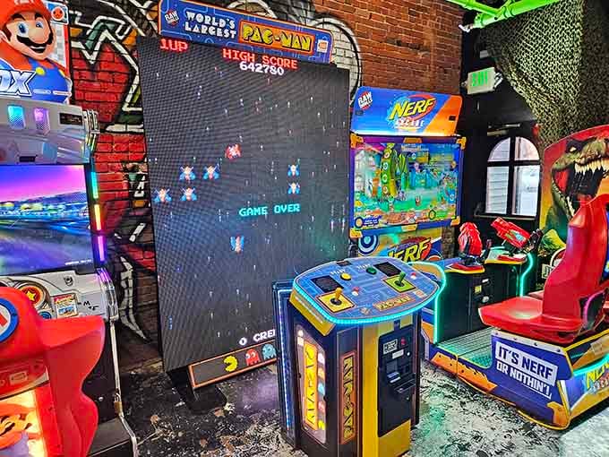 Pac-Man towers over the room like a yellow deity, still hungry after all these years and ready for worship.