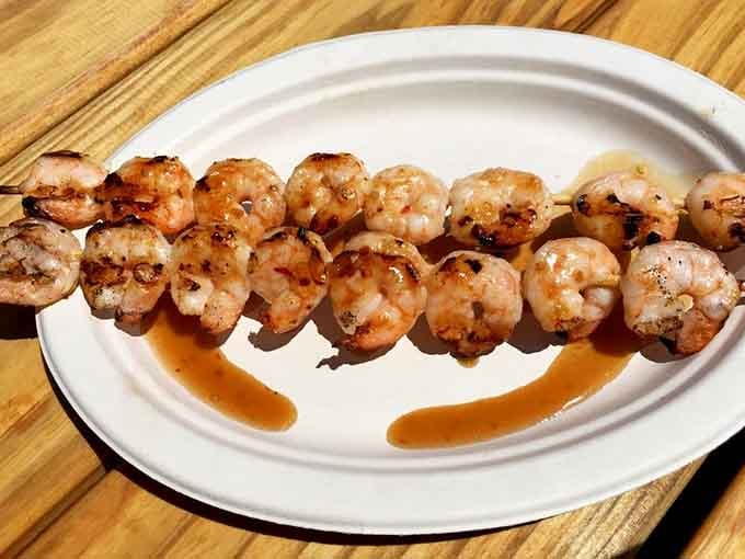 Grilled shrimp skewers so perfectly charred, they could make a vegetarian reconsider their life choices entirely.