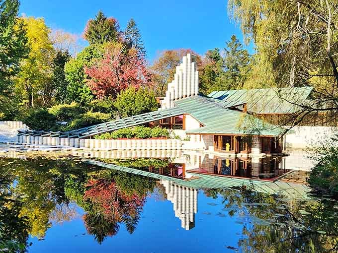 The studio's reflection in still water creates a mirror image that'll make you question which side is real.