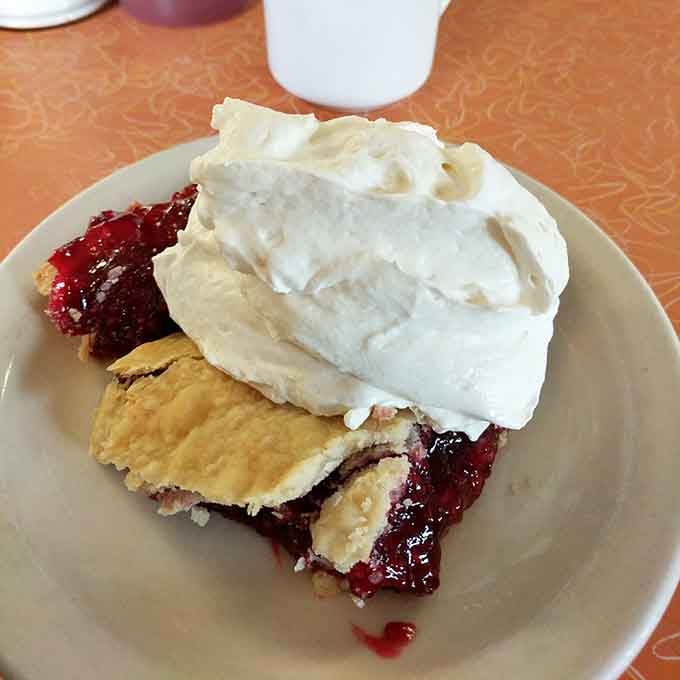 That fluffy meringue topping sits like a cloud on cherry pie perfection, ready to make your day infinitely better.