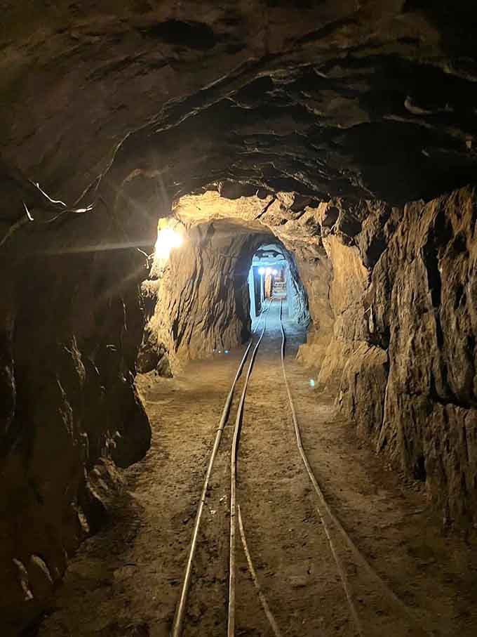 Rails stretch through hand-carved tunnels where every inch represents hours of backbreaking labor by candlelight and determination.