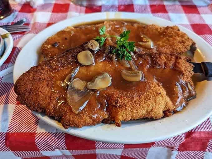 The j&auml;gerschnitzel arrives golden and glistening, topped with mushroom gravy that could make a vegetarian reconsider their life choices.