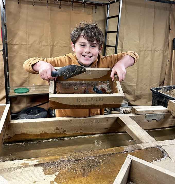 That grin says it all: he just found something amazing in a bucket of mud.