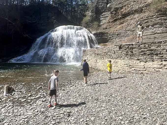 Families gather on the rocky shore, drawn to the water like it's the neighborhood pool, only infinitely better.
