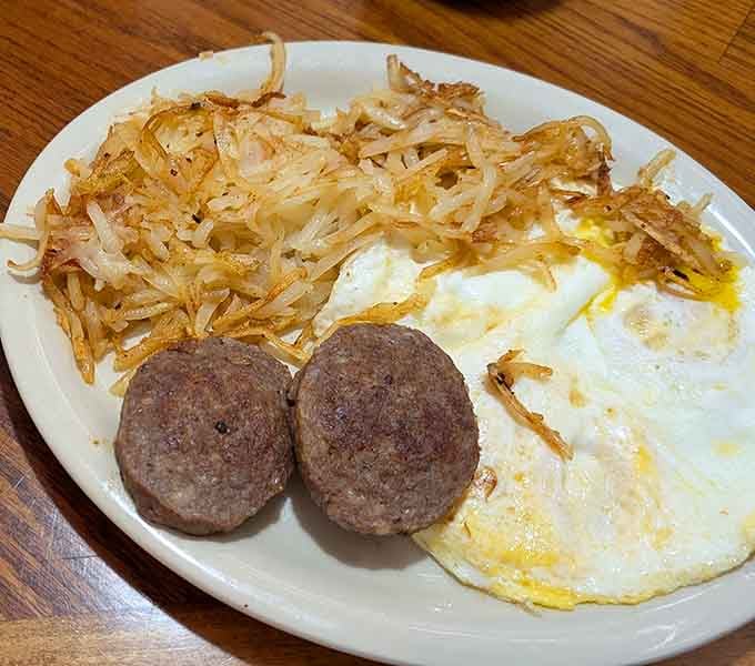 Golden hash browns, perfectly cooked eggs, and sausage links create the breakfast trifecta that never gets old.