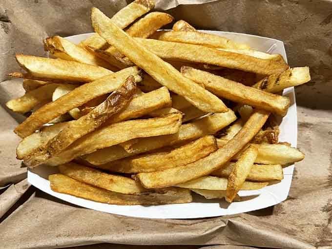Hand-cut fries with that perfect golden ratio of crispy exterior to fluffy interior – simple perfection on a plate.