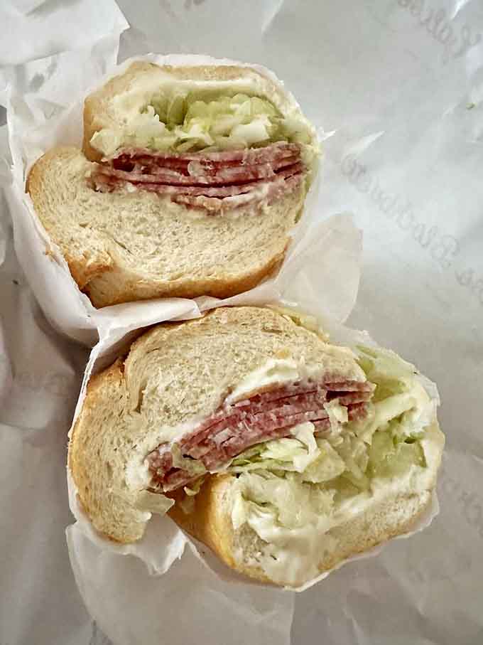 Layers of salami stacked high between fresh bread, this isn't a sandwich, it's an architectural achievement worth celebrating.