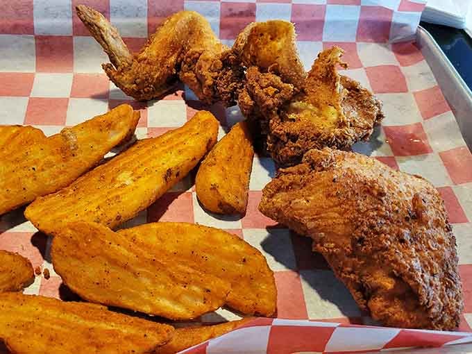 Golden fried chicken and seasoned JoJo's on checkered paper: this is what happiness looks like, folks.