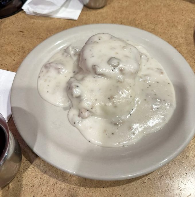 Biscuits drowning in sausage gravy: the breakfast equivalent of a warm hug from someone who actually likes you.
