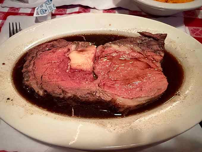 Behold the prime rib in all its glory, swimming in au jus like it's taking a victory lap.