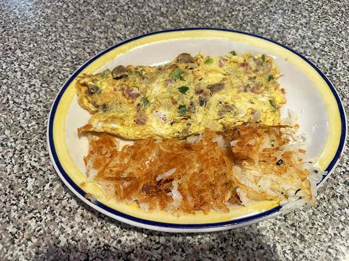 That omelet with hash browns proves golden-brown perfection is achievable and sitting right in front of you.