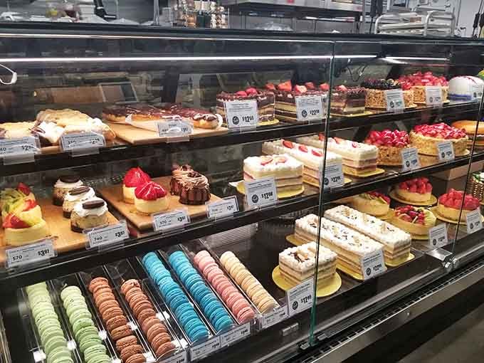 Macarons and elaborate cakes sit side by side like edible art that's begging you to ruin your dinner plans immediately.