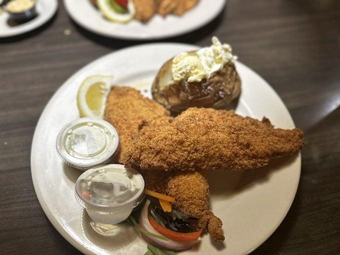 Golden-crusted catfish paired with a loaded baked potato proves simple done right beats fancy every time.